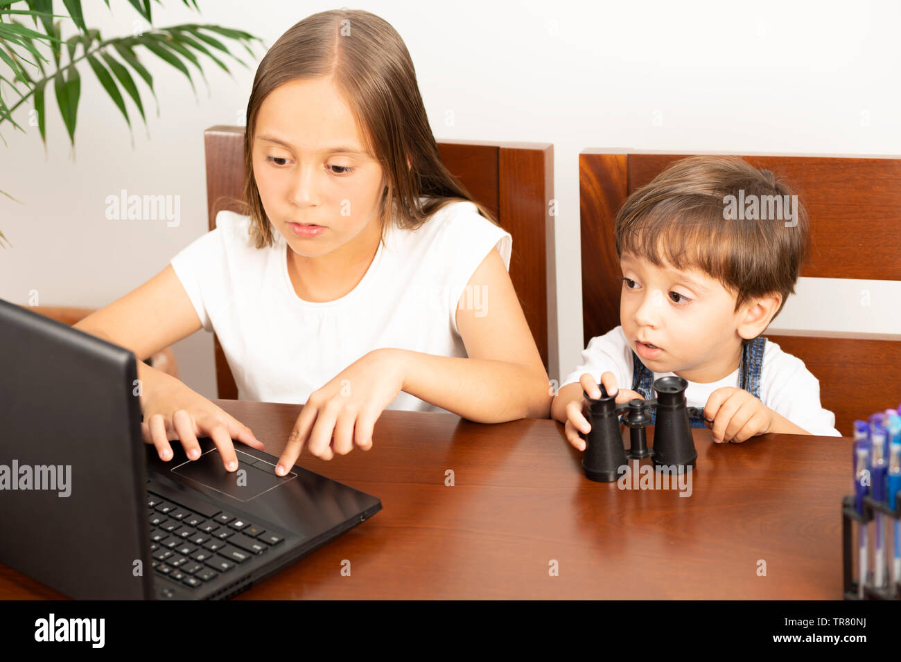 Happy Girl and Boy Sitting at his Desk With Laptop Computer Stock Photo ...