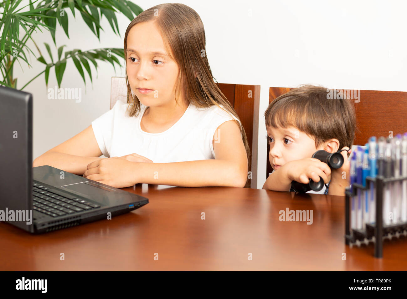 Happy Girl and Boy Sitting at his Desk With Laptop Computer Stock Photo ...