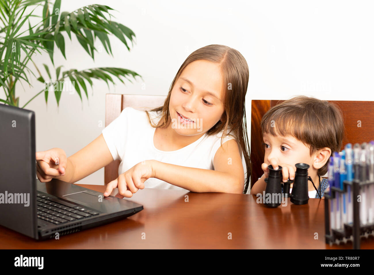 Happy Girl and Boy Sitting at his Desk With Laptop Computer Stock Photo ...