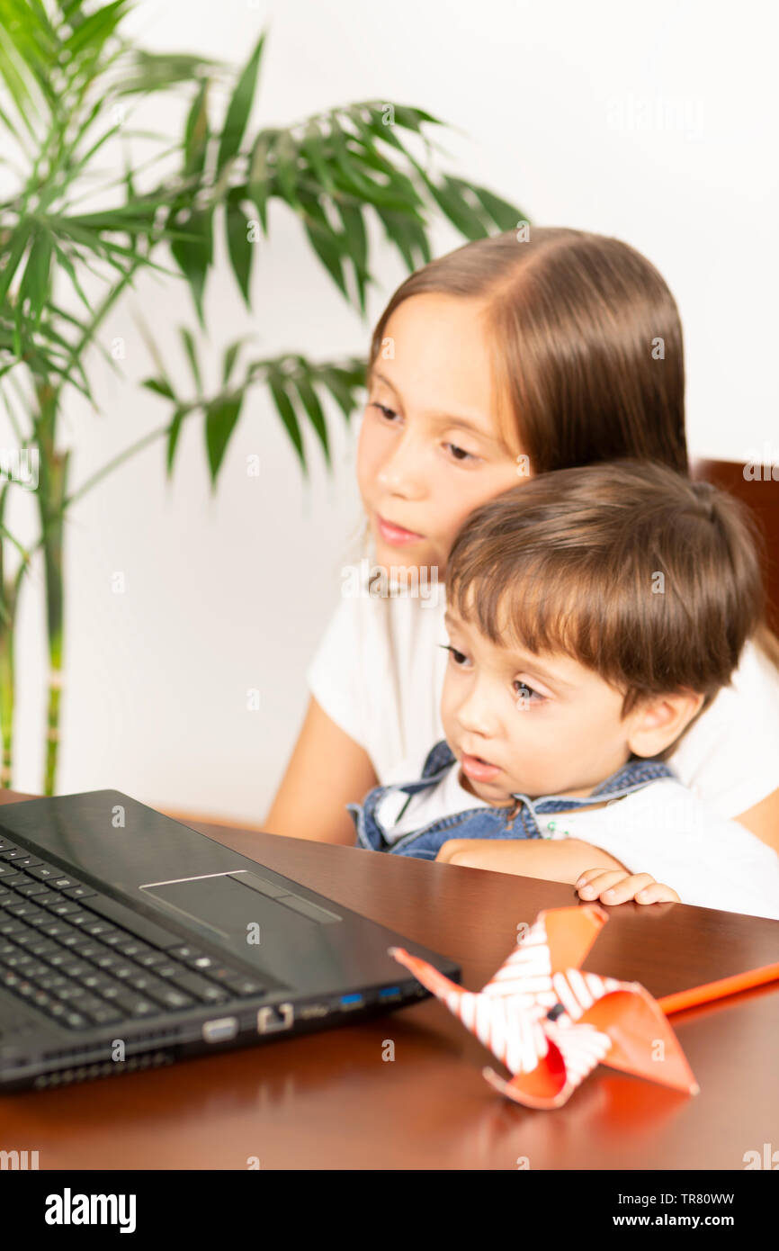 Happy Girl and Boy Sitting at his Desk With Laptop Computer Stock Photo ...