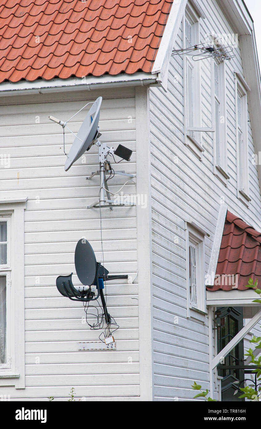 Satelite dishes and antenna on a white wooden house Stock Photo - Alamy