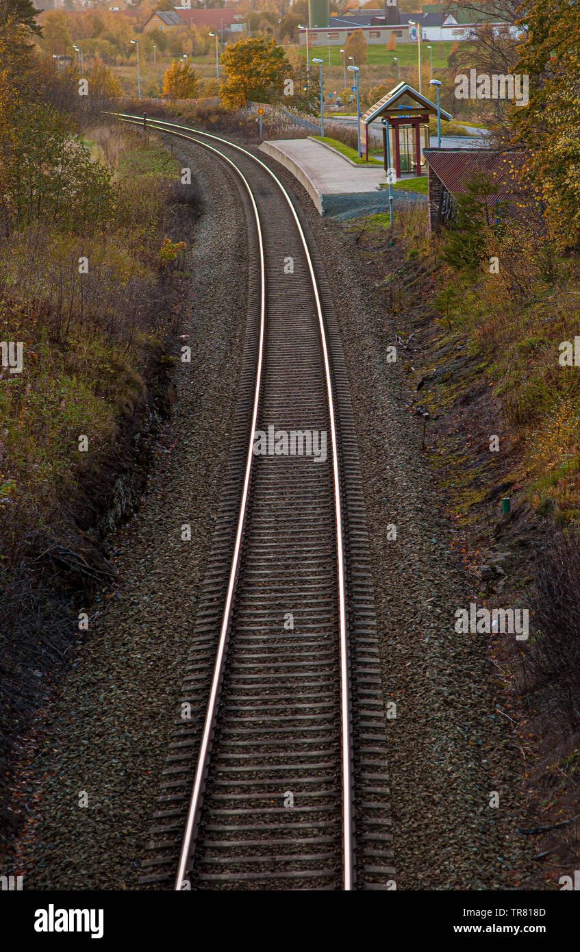Curved railway tracks with at small station Stock Photo - Alamy
