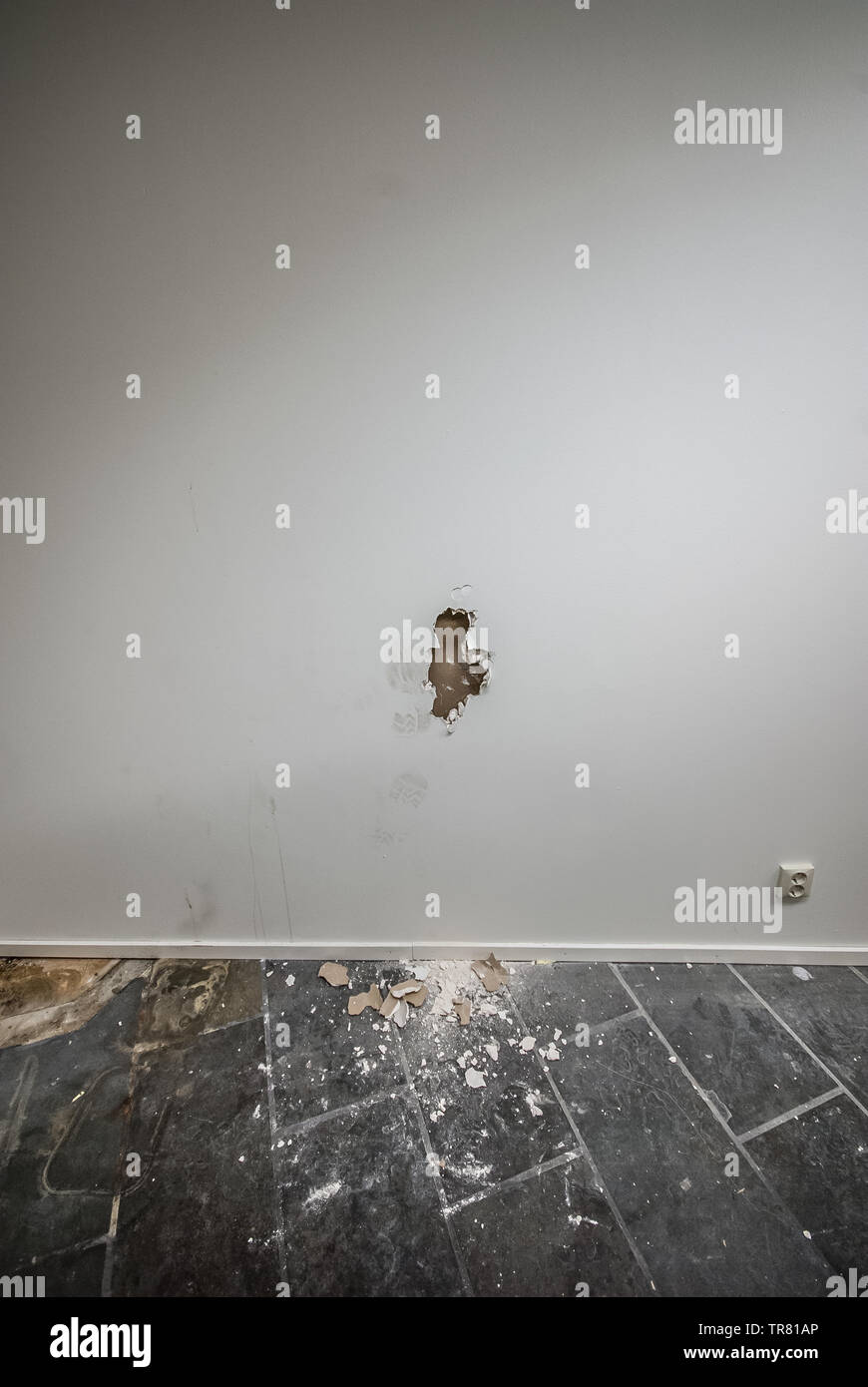 A hole in a white, plaster wall Stock Photo - Alamy