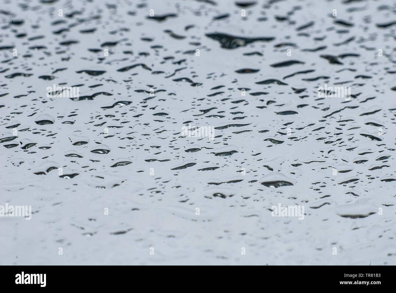 Water spray on a glass mirror with reflections Stock Photo - Alamy