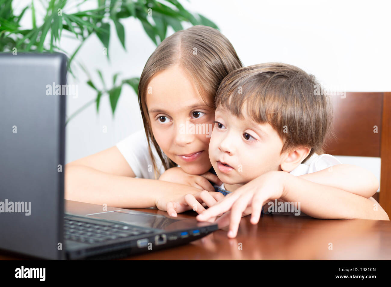 Happy Girl and Boy Sitting at his Desk With Laptop Computer Stock Photo ...