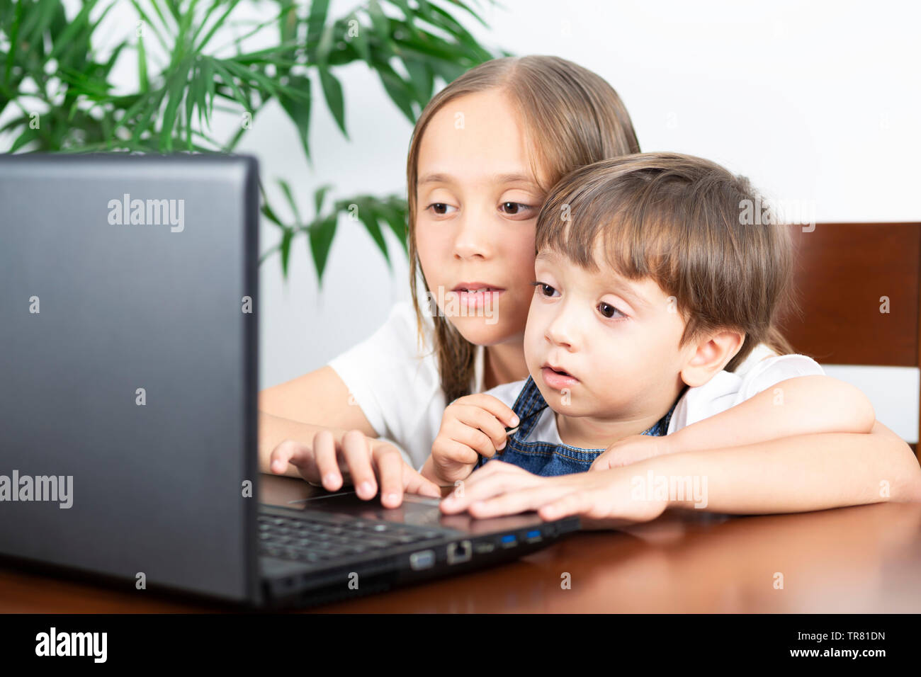 Happy Girl and Boy Sitting at his Desk With Laptop Computer Stock Photo ...