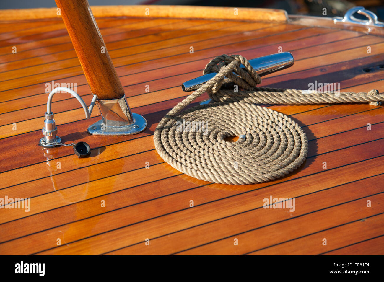 Rope neatly coiled on the wooden deck of a boat Stock Photo - Alamy