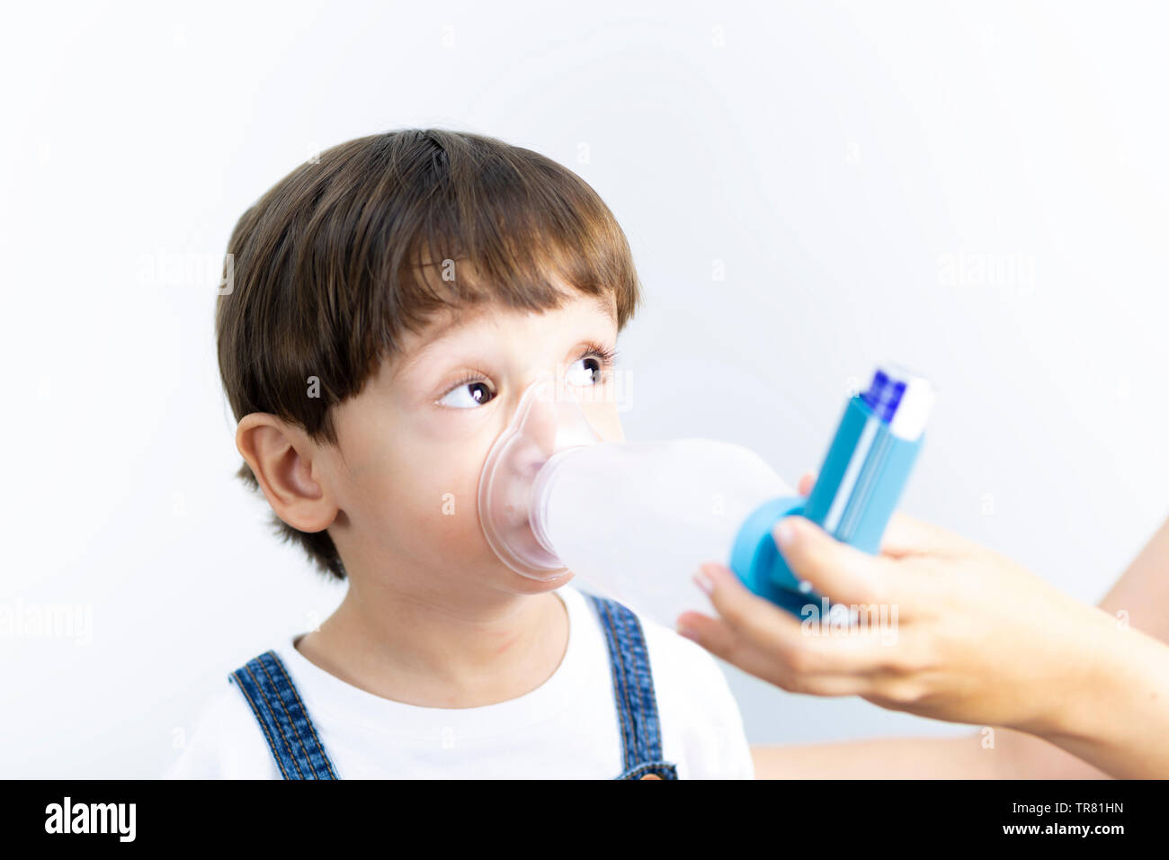 Young boy using inhaler for asthma and respiratory diseases Stock Photo ...