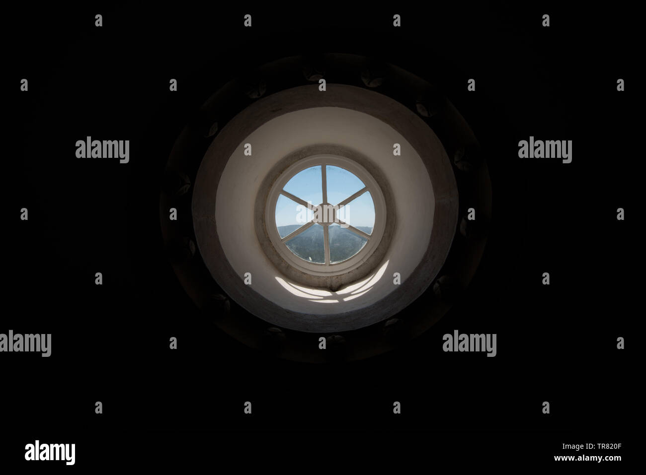 Round window sunny landscape outside, black interior Stock Photo - Alamy