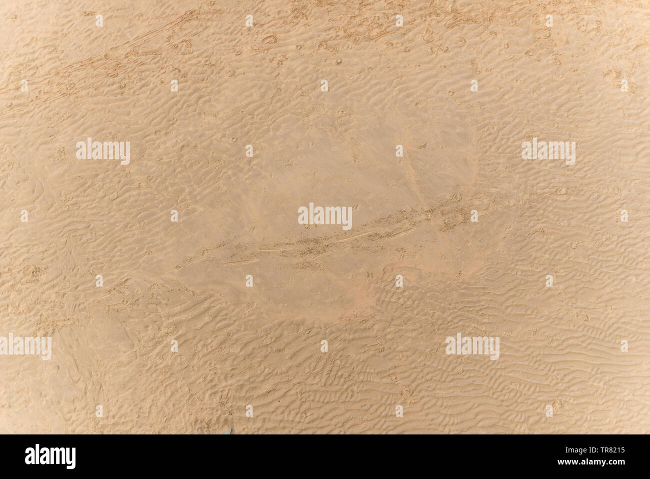 Sandy beach with footprints seen from above Stock Photo - Alamy