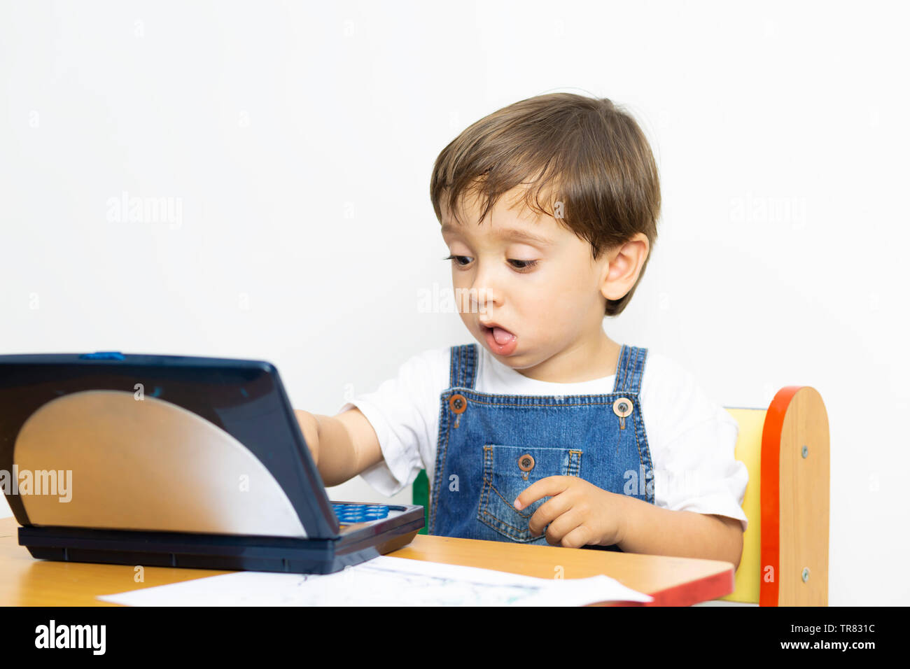Happy Boy Sitting at his Desk With Laptop Computer Stock Photo - Alamy