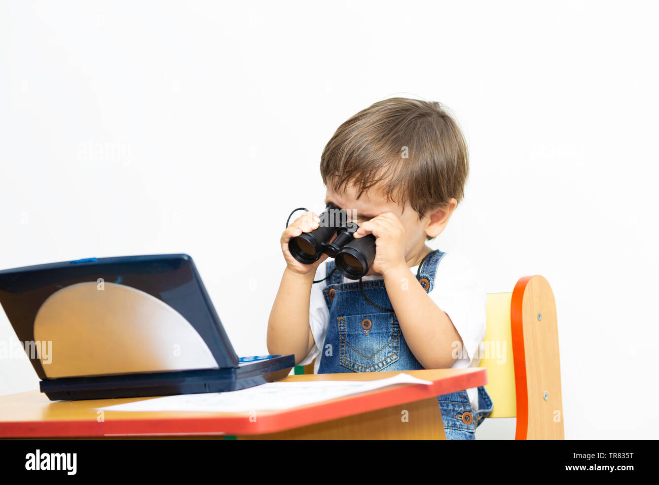 Happy Boy Playing with Laptop and Binoculars Stock Photo - Alamy