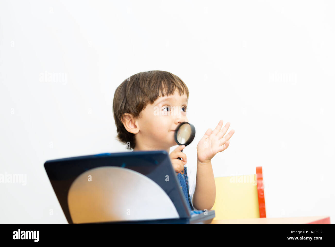 Happy Boy Sitting at his Desk With Laptop Computer Stock Photo - Alamy
