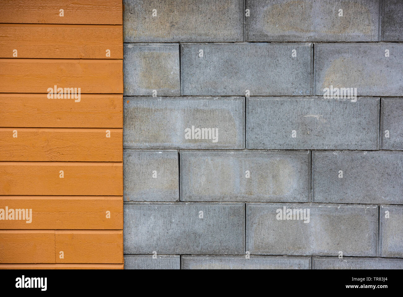 Wall with part cement blocks, part yellow wood panelling Stock Photo ...