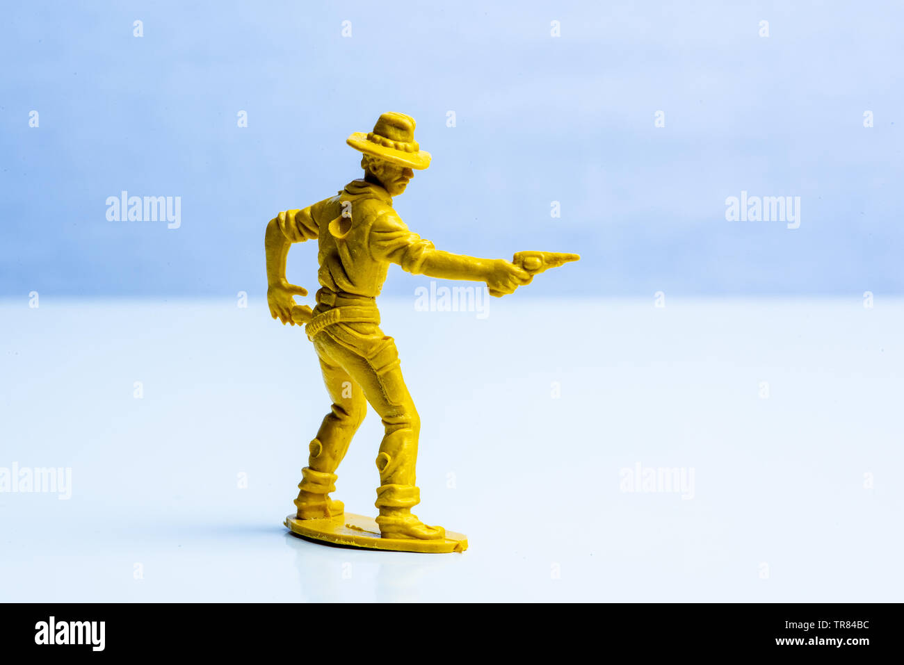 Yellow cowboy plastic toy figure Stock Photo - Alamy