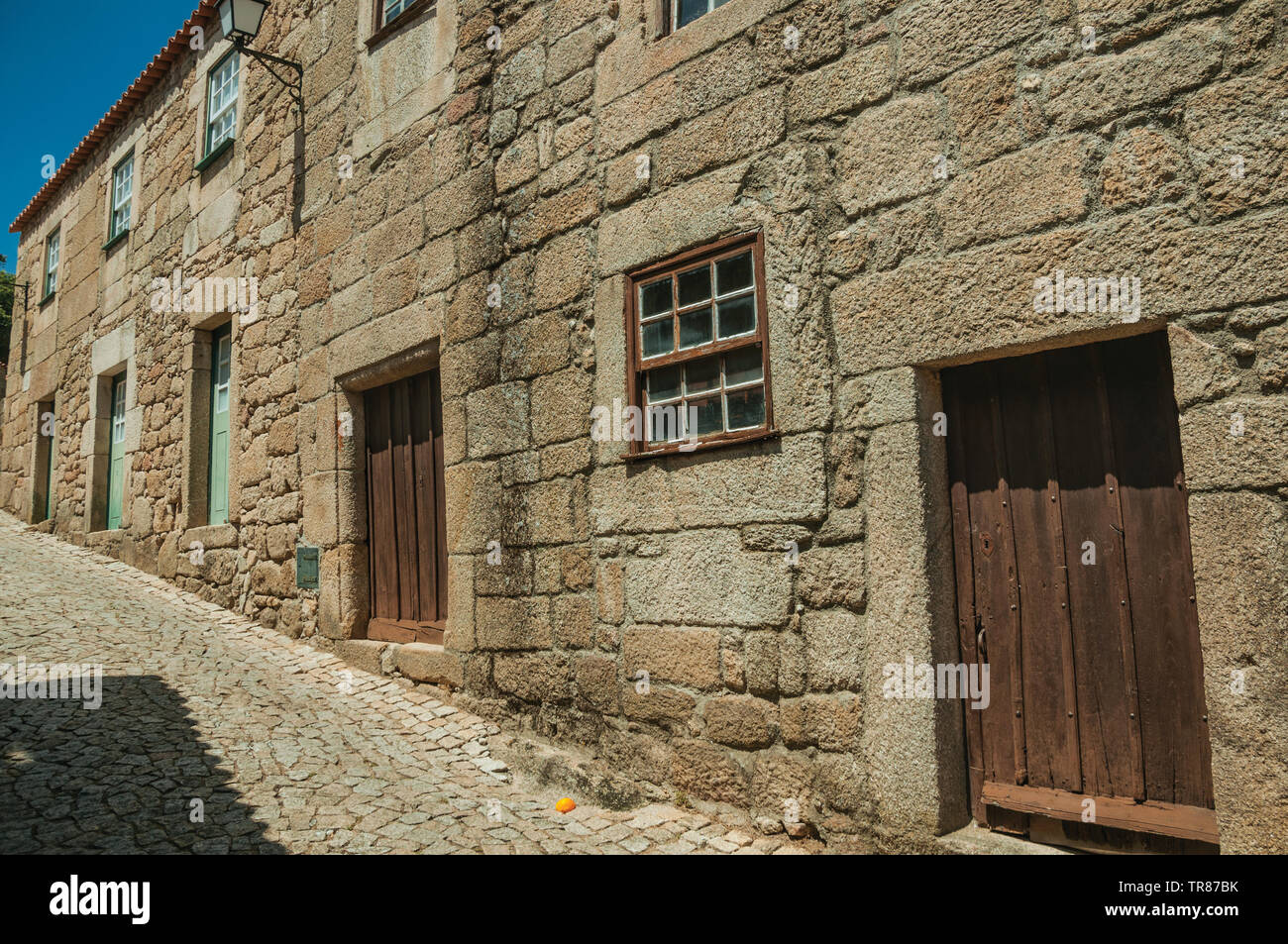 Gothic house made of stone and deserted alley on slope at Sortelha. An ...
