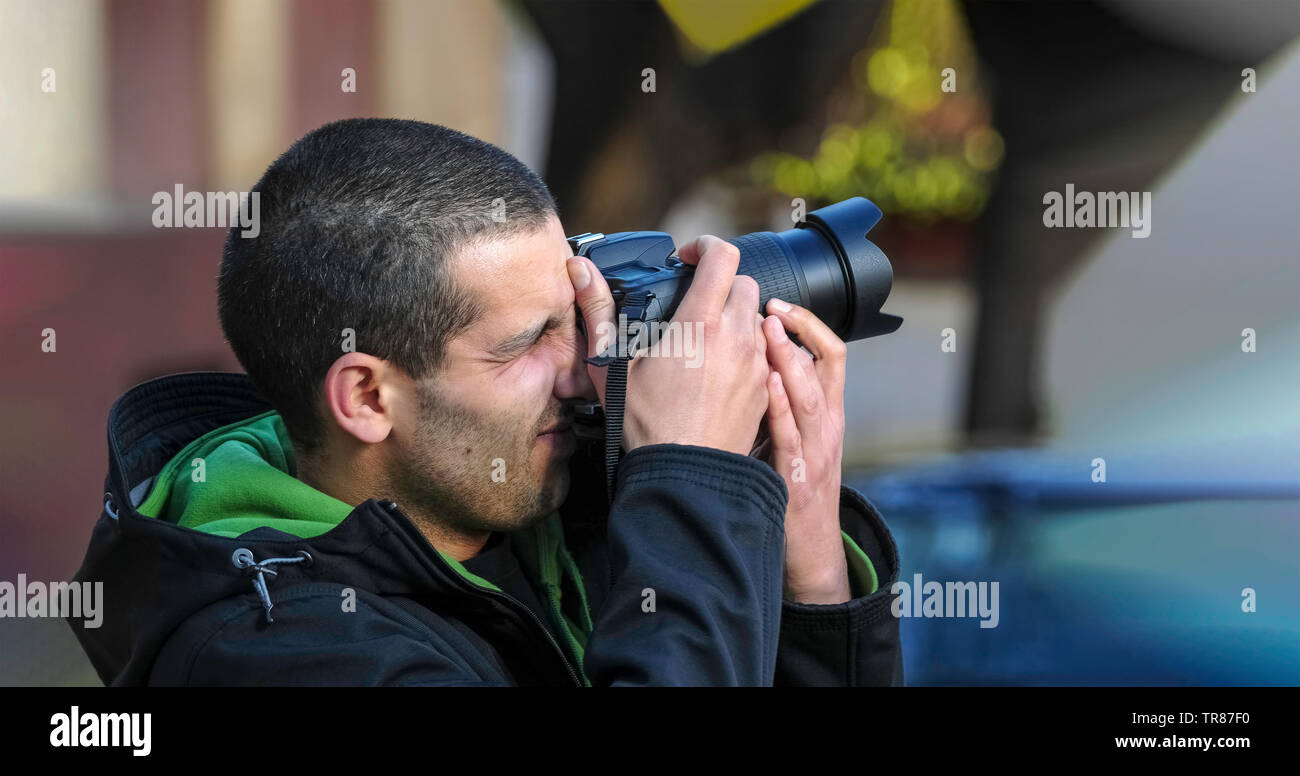 Close up profile portrait of photographer taking photo - Side view of ...