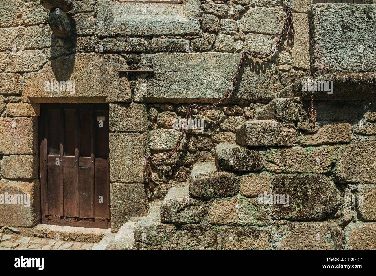 Gothic house with stone staircase and wooden door on deserted alley at ...