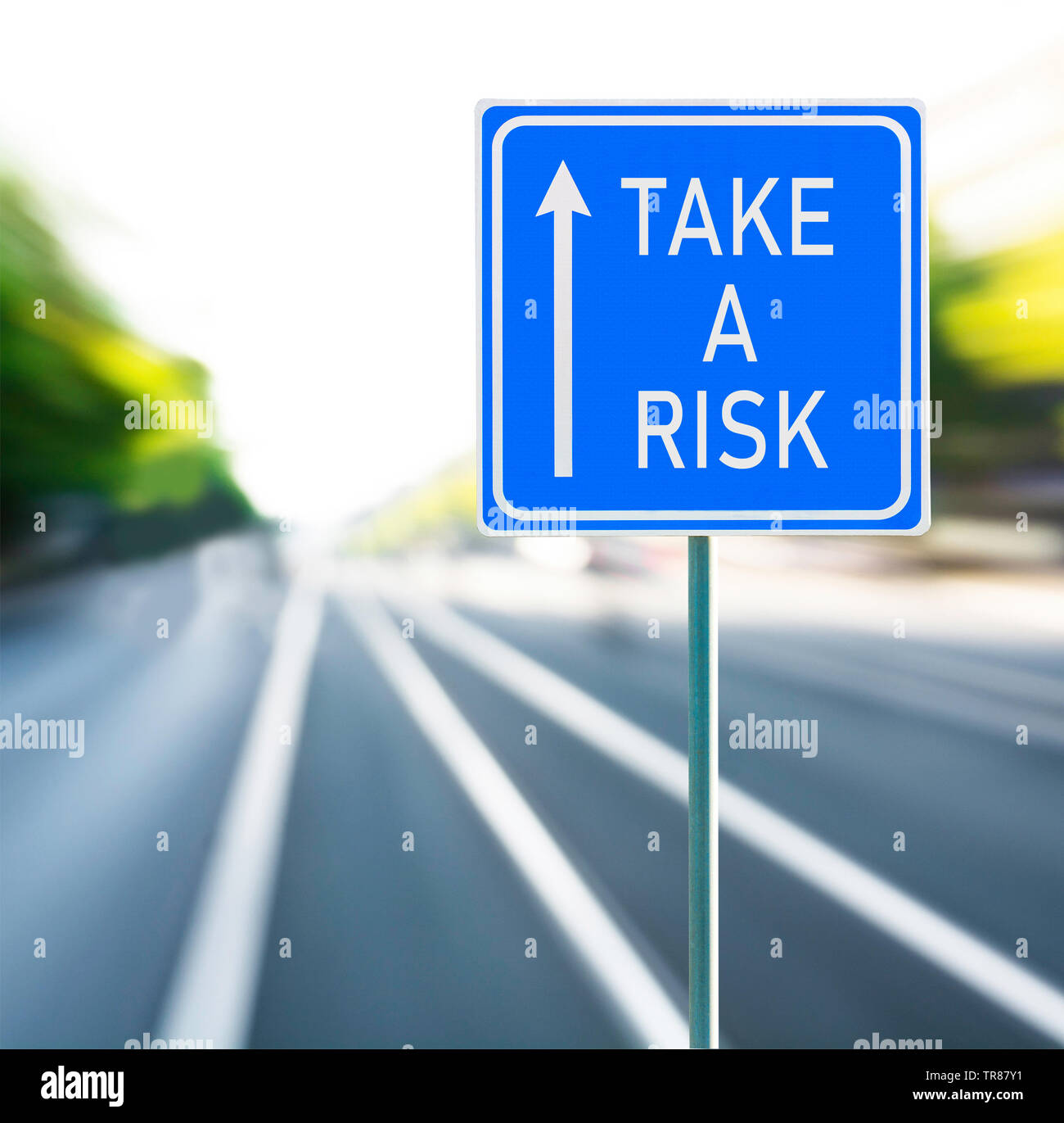 Take a risk motivational phrase on blue road sign with arrow and ...