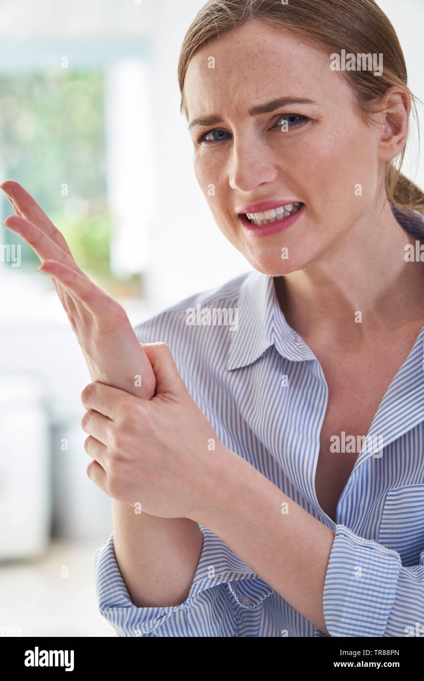 Portrait Of Woman In Pain Holding Wrist Suffering With Repetitive ...