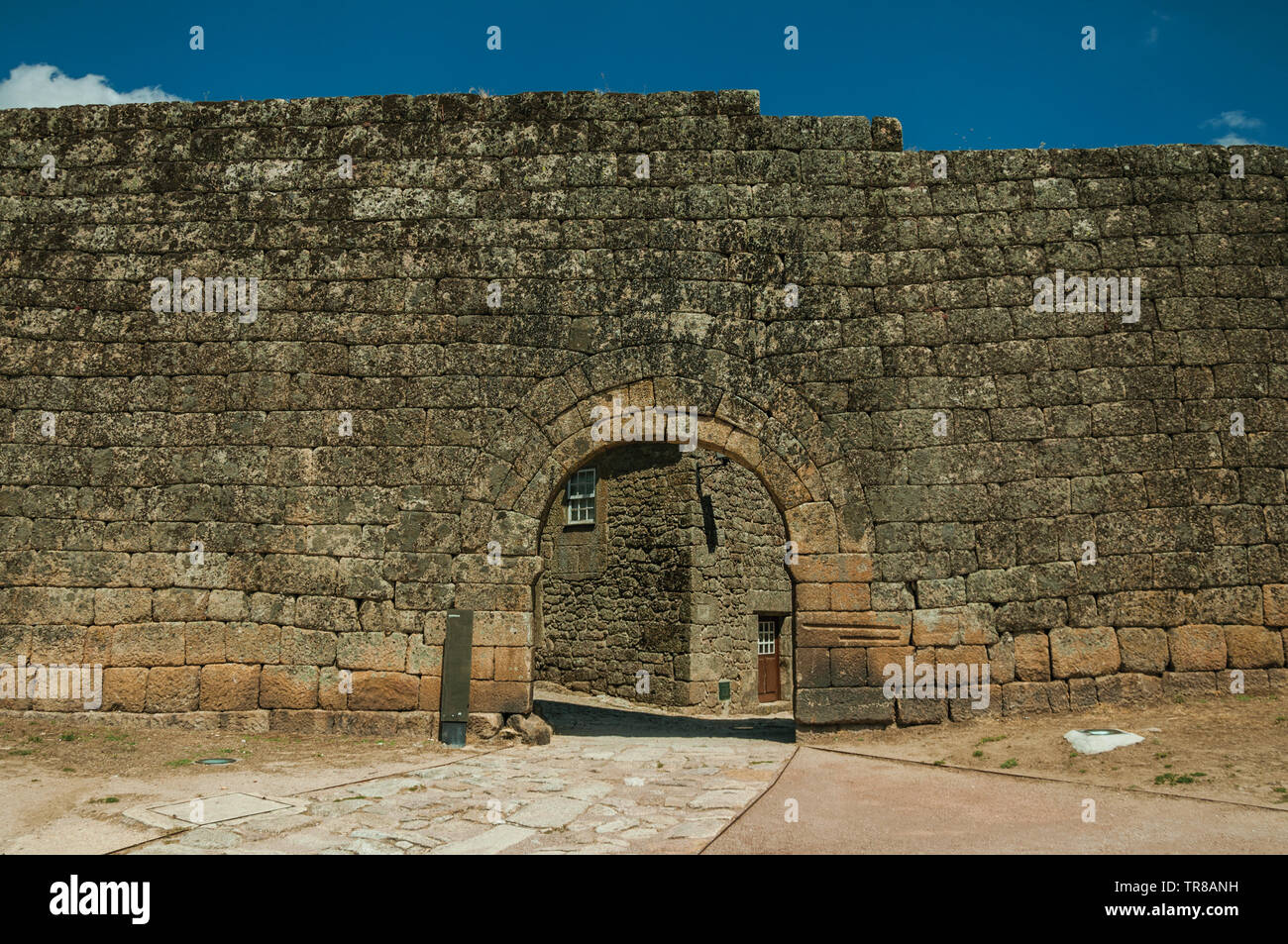 Open gate arch on a stone outer wall, at the historic city center of ...