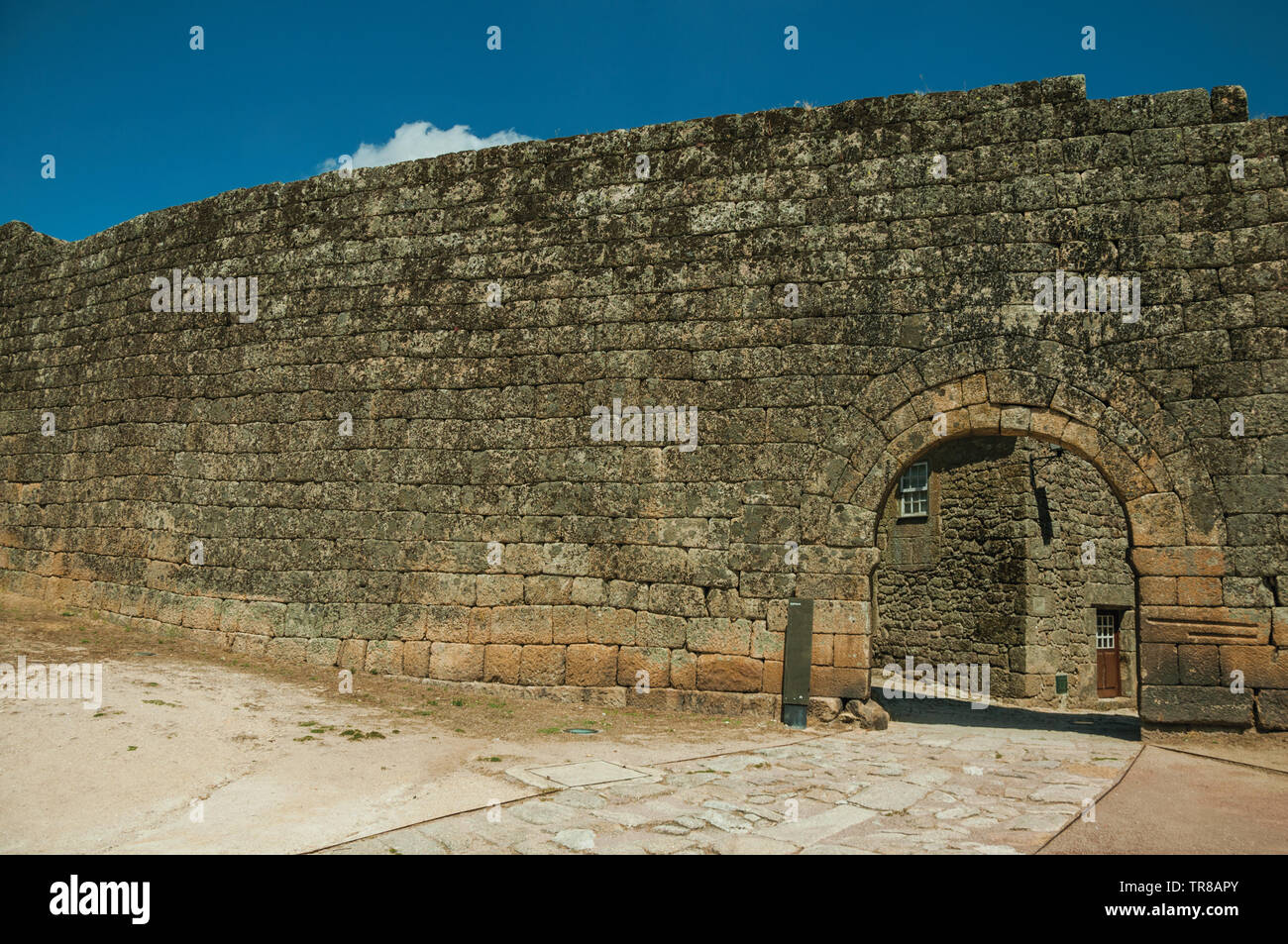Open gate arch on a stone outer wall, at the historic city center of ...