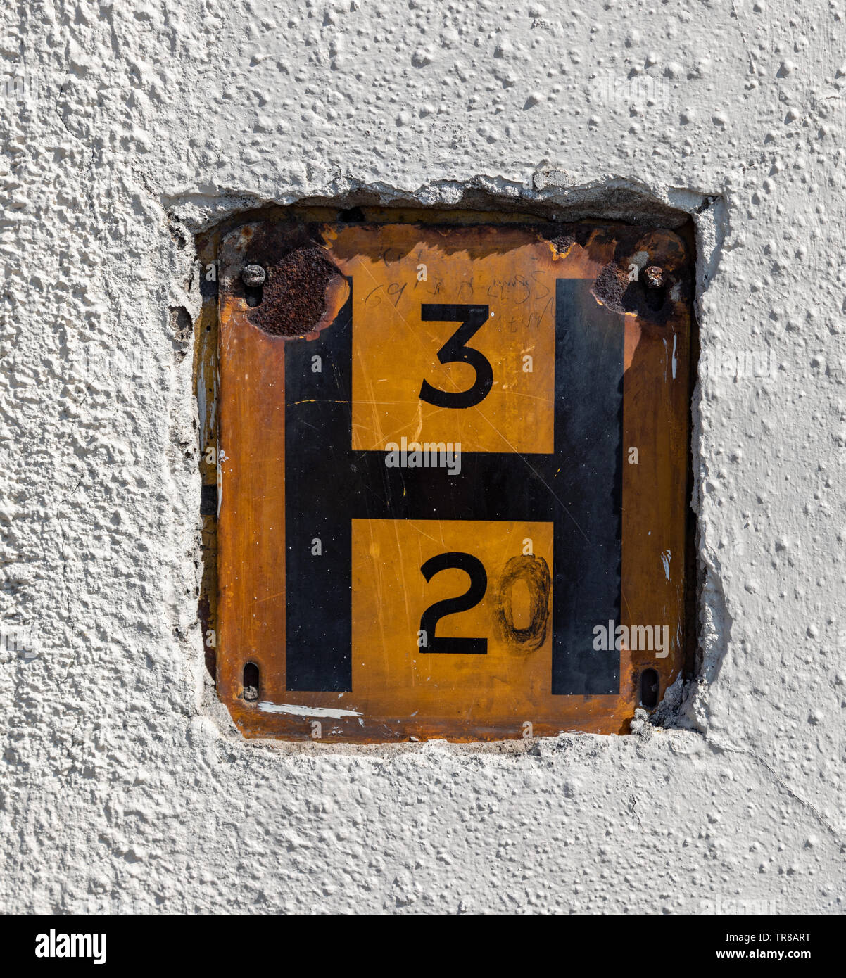Square fire hydrant sign in a wall in the town centre of Widnes April ...
