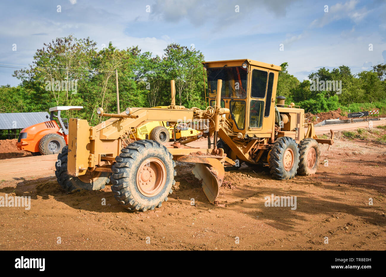 Road construction with motor grader / yellow of modern grader with ... Road construction with motor grader / yellow of modern grader with ...