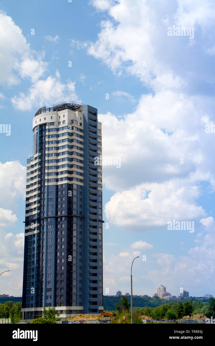 Modern skyscraper residential building and construction equipment over ...