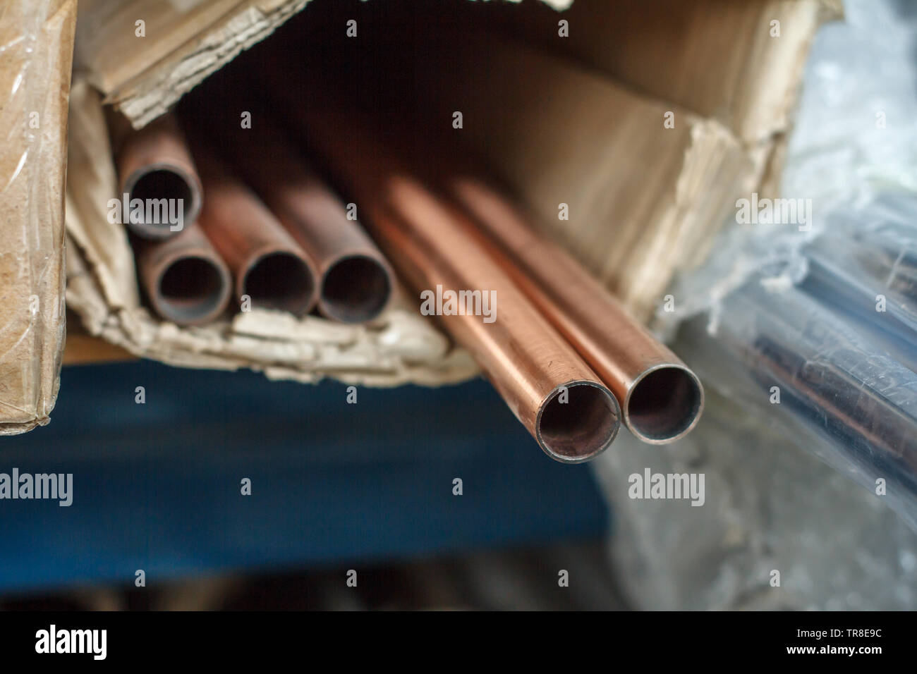 Closeup of a stack of copper pipes for water and heating systems, soft ...