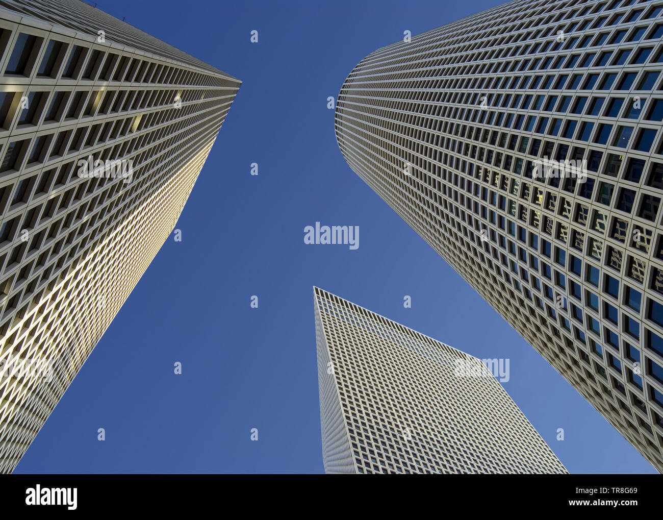 Skyscraper tops against blue sky. Bottom view Stock Photo - Alamy