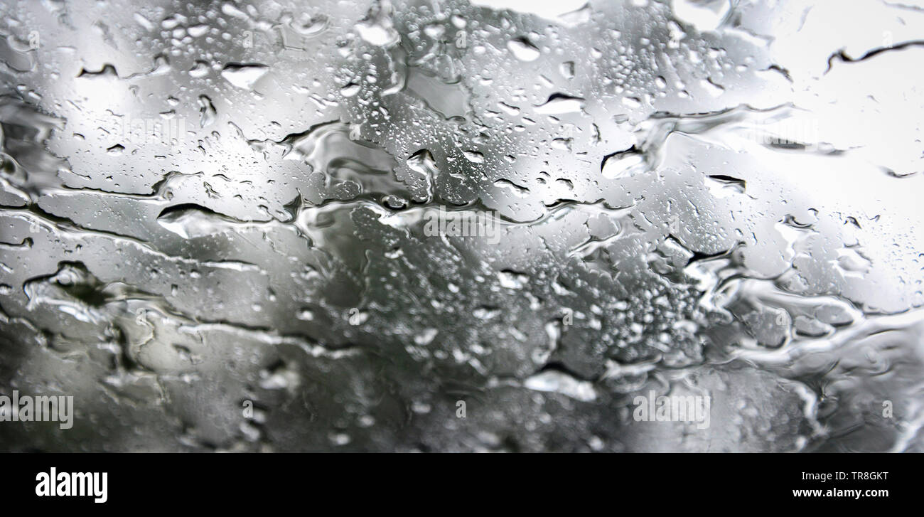 Rain drops on glass / Rainy day window glass with water drops and ...