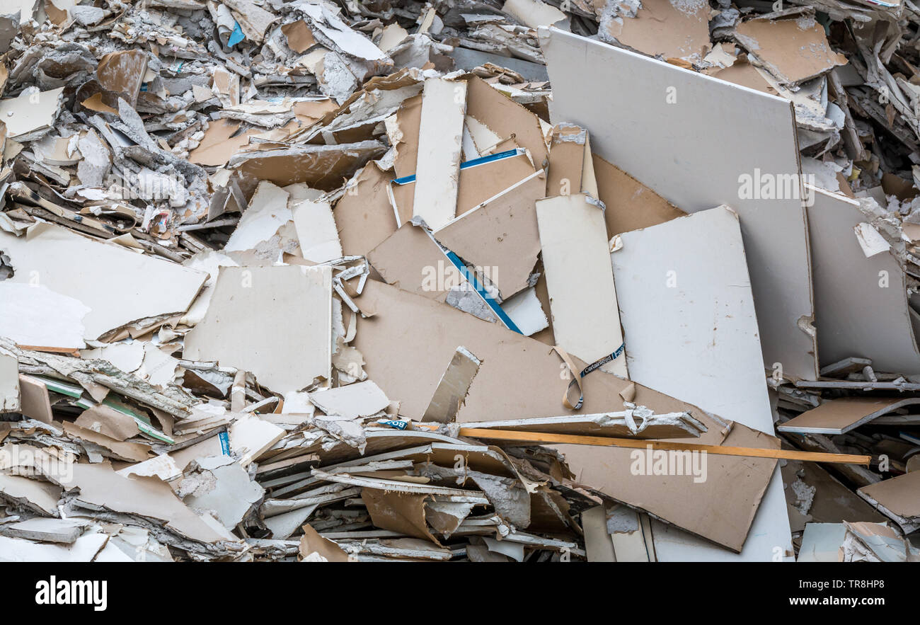 A large pile of gypsum board awaits shipping to a recycling facility ...