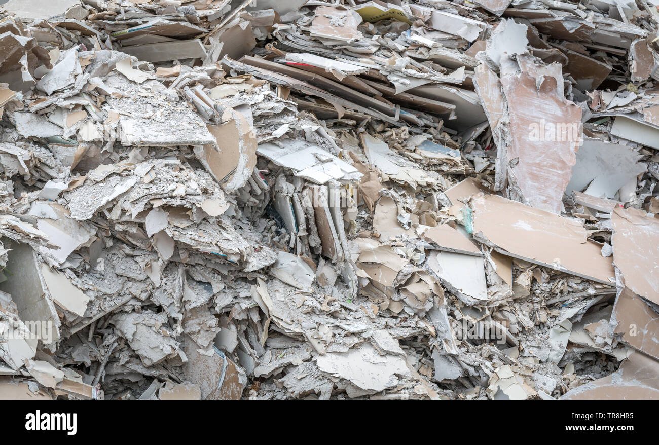 A large pile of gypsum board awaits shipping to a recycling facility ...