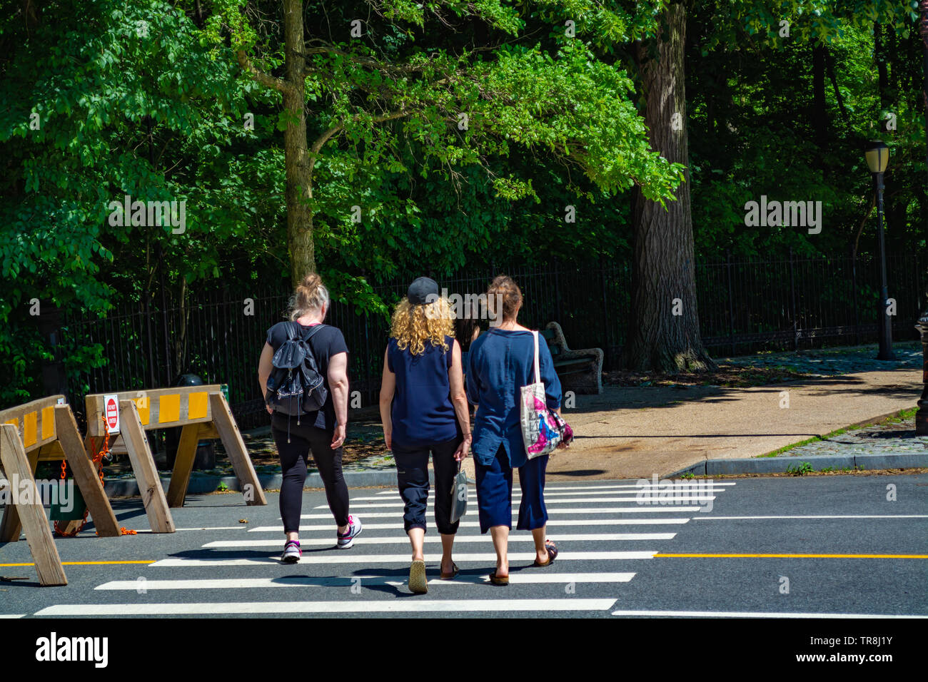 Three ladies are crossing the street Stock Photo - Alamy