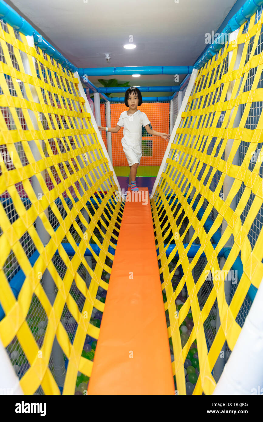 Asian Chinese little girl playing at indoor playground alone Stock ...