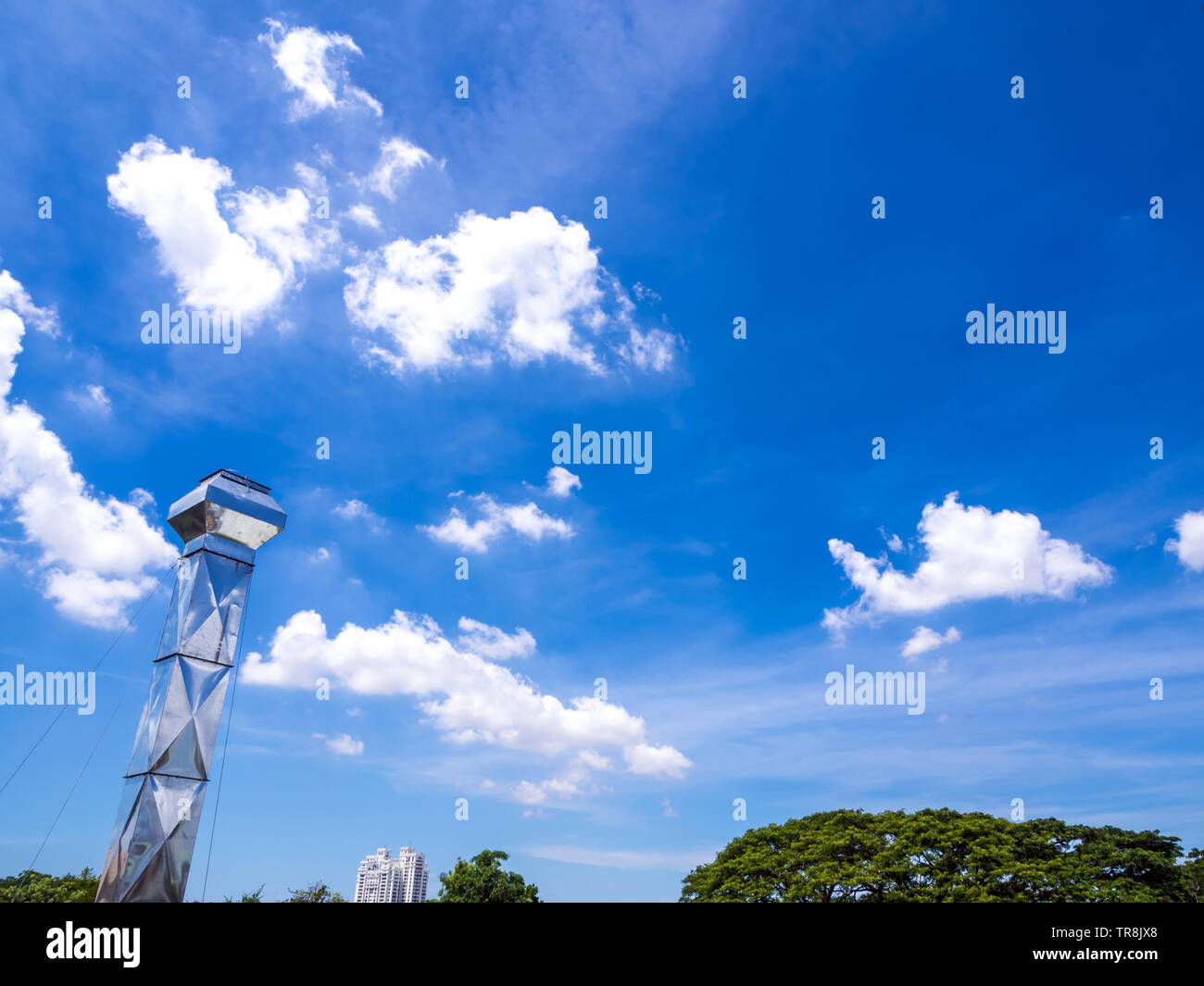 Shiny steel smokestack and cloud in blue sky Stock Photo - Alamy