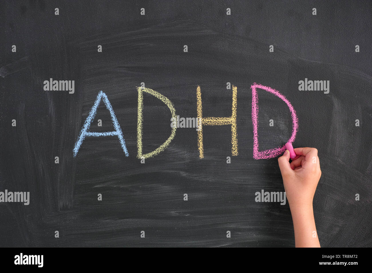 ADHD. Child writing Abbreviation ADHD on a blackboard. ADHD is ...