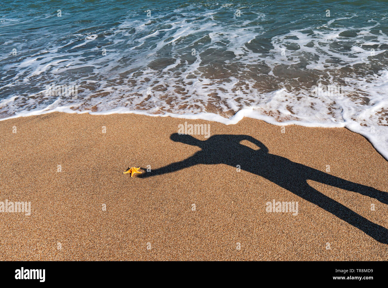 Man shadow on the hot sea sand Stock Photo - Alamy