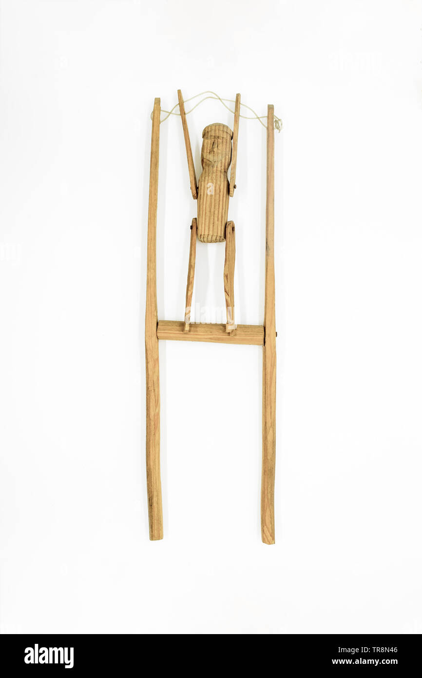 Old and handmade wooden bouncing human shape figurine toy on white ...