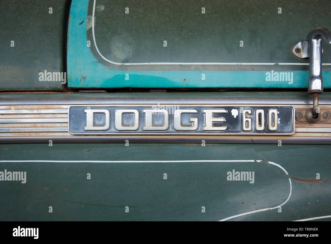 A close up of the word Dodge 600 in raised chrome lettering on a name ...