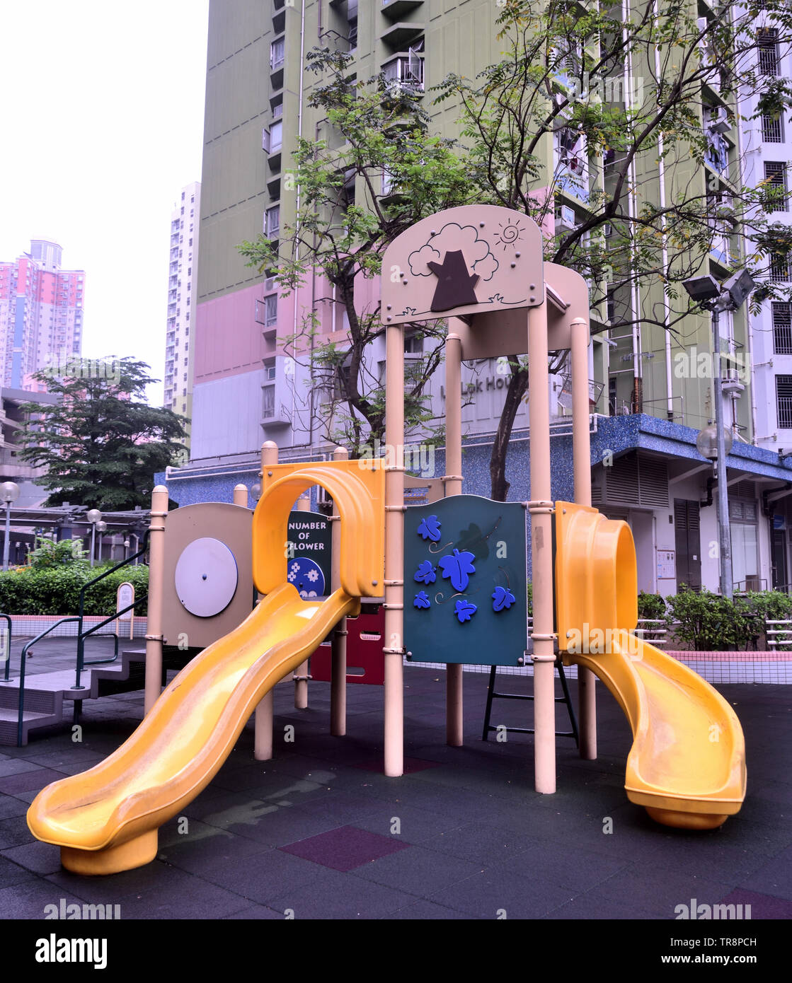 Yellow slides on playground Stock Photo - Alamy