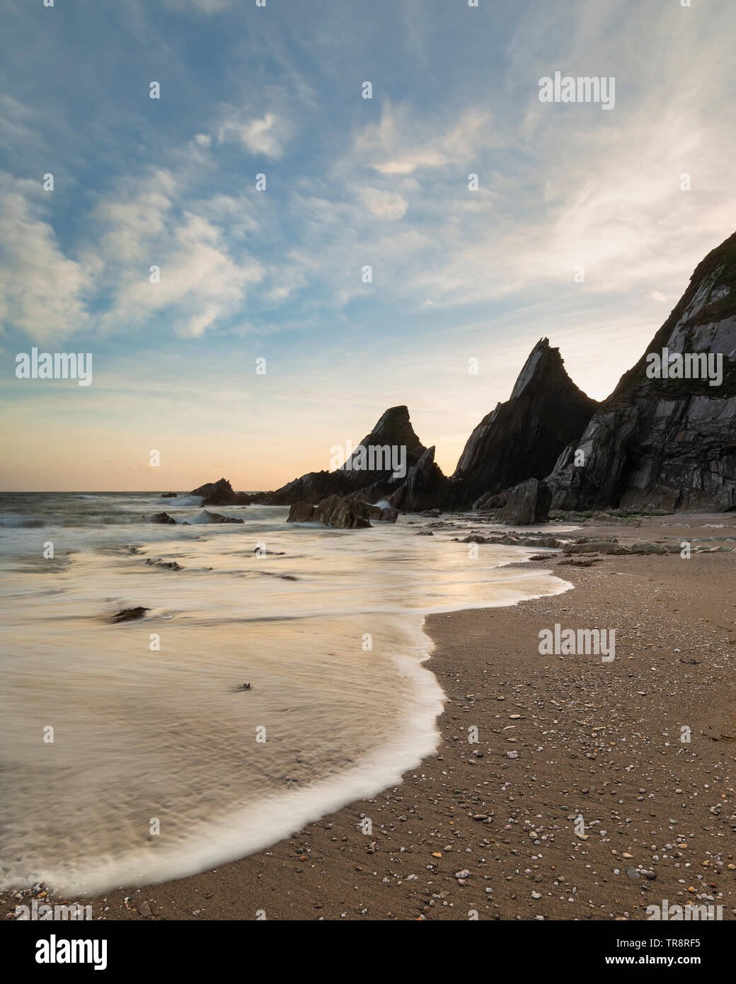 Beautiful sunset landscape image of Westcombe Beach in Devon England ...