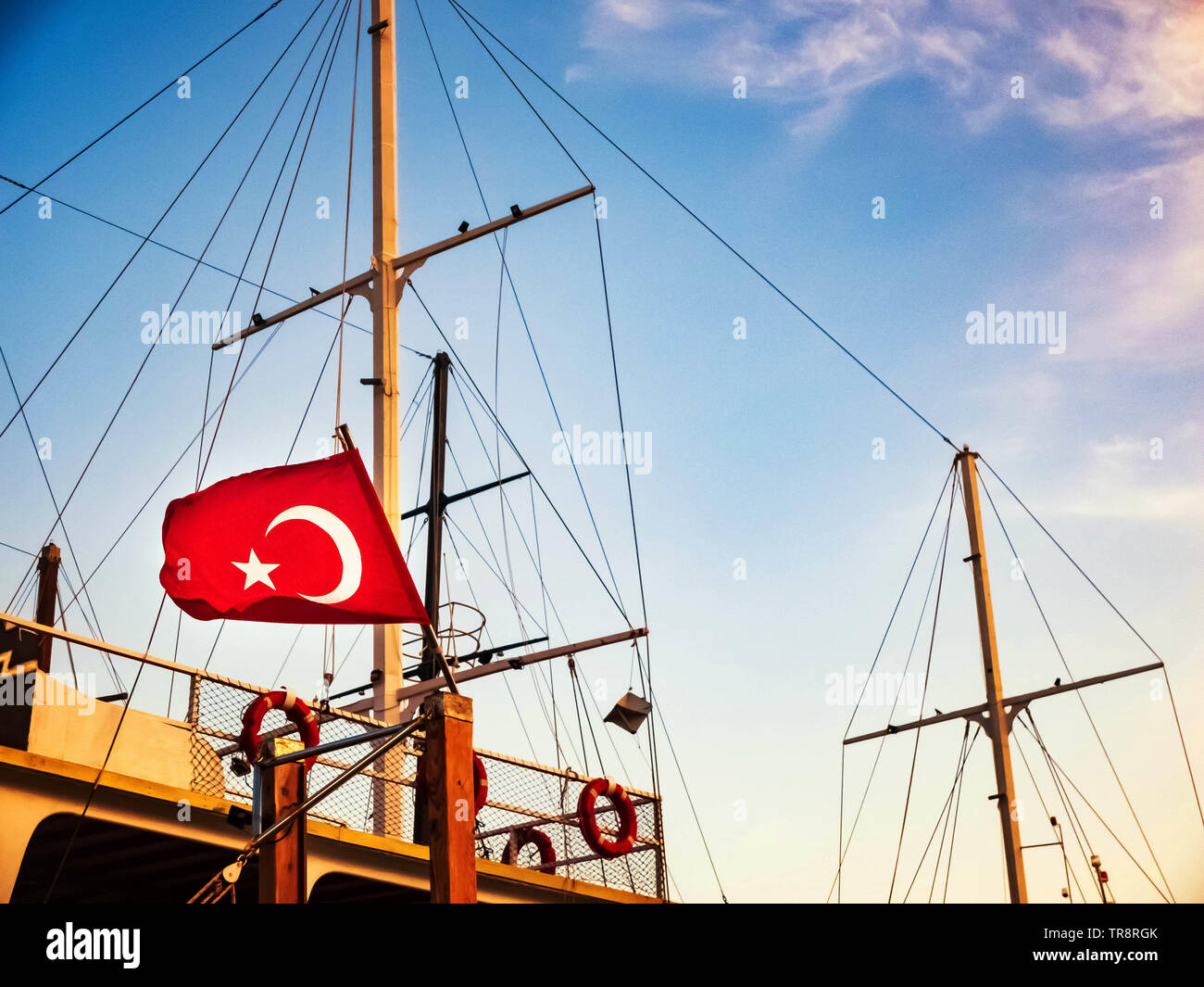 Turkish flag is waving on the top of nautical vessel against masts and ...