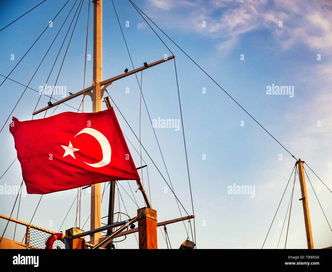 Turkish flag is waving on the top of nautical vessel against masts and ...