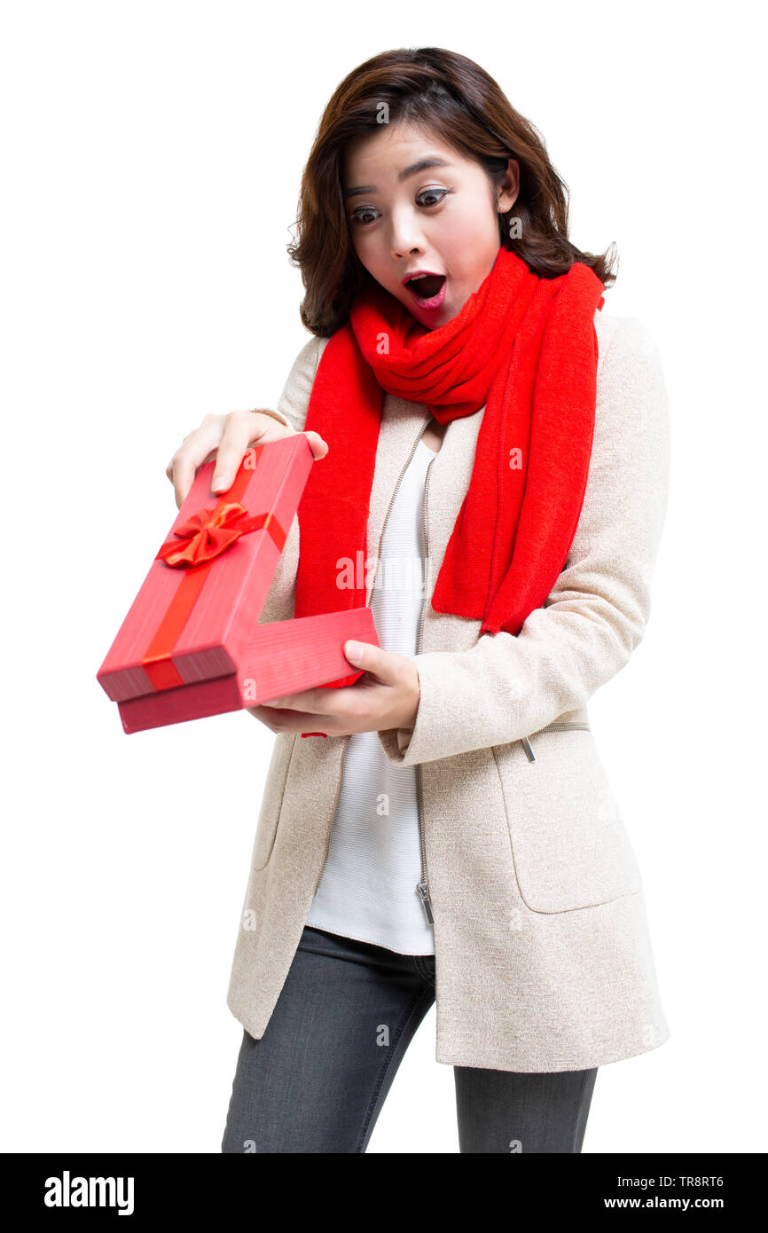 Happy young woman unwrapping gift Stock Photo - Alamy