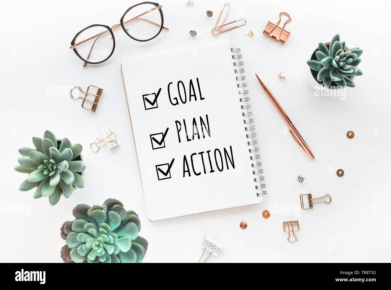 Goal,plan,action text on notepad with office accessories.Business ...