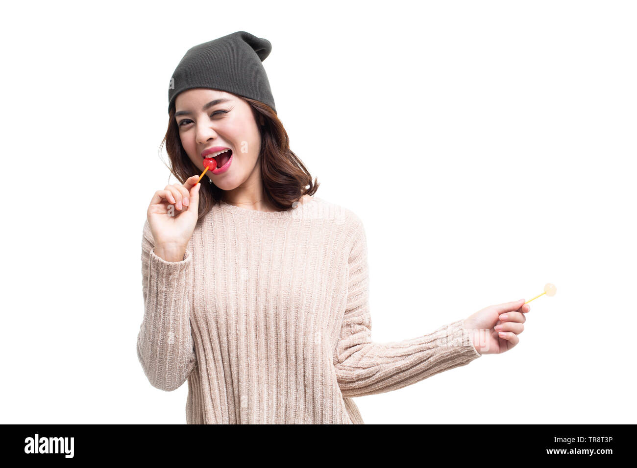 Happy young woman eating lollipop Stock Photo - Alamy