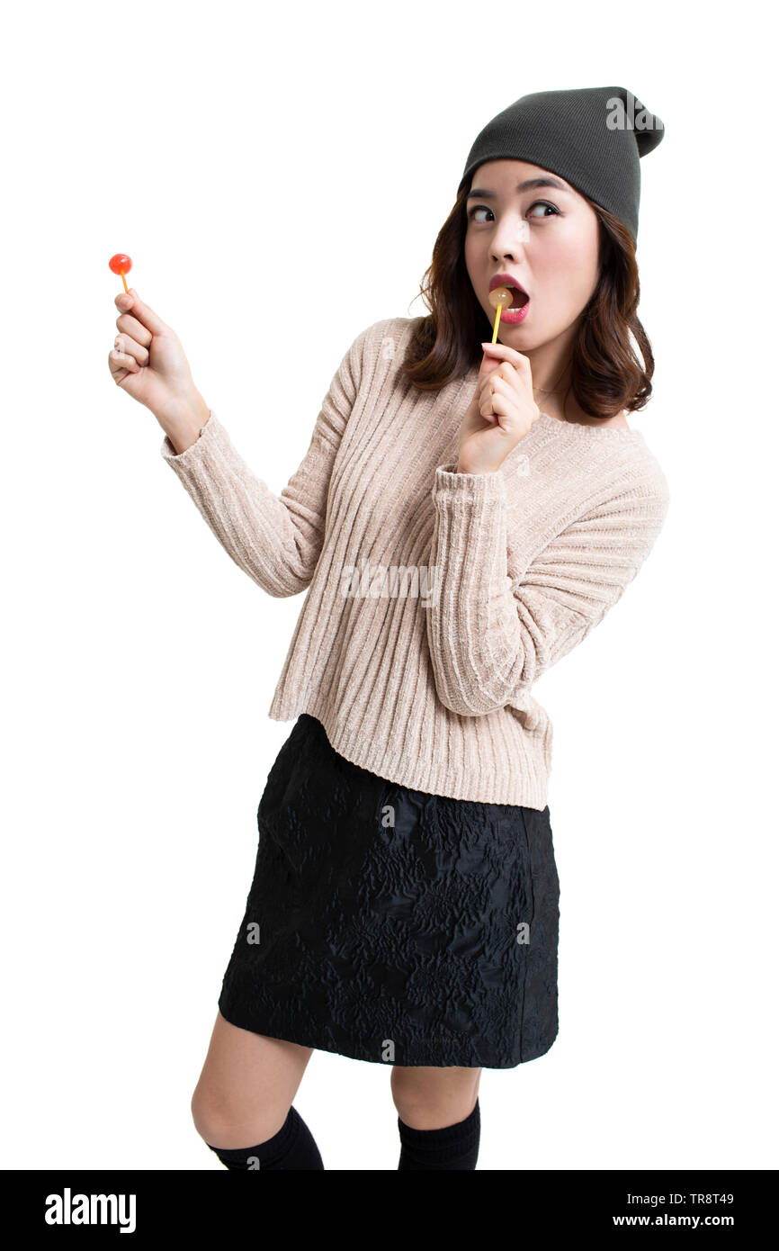 Happy young woman eating lollipop Stock Photo - Alamy