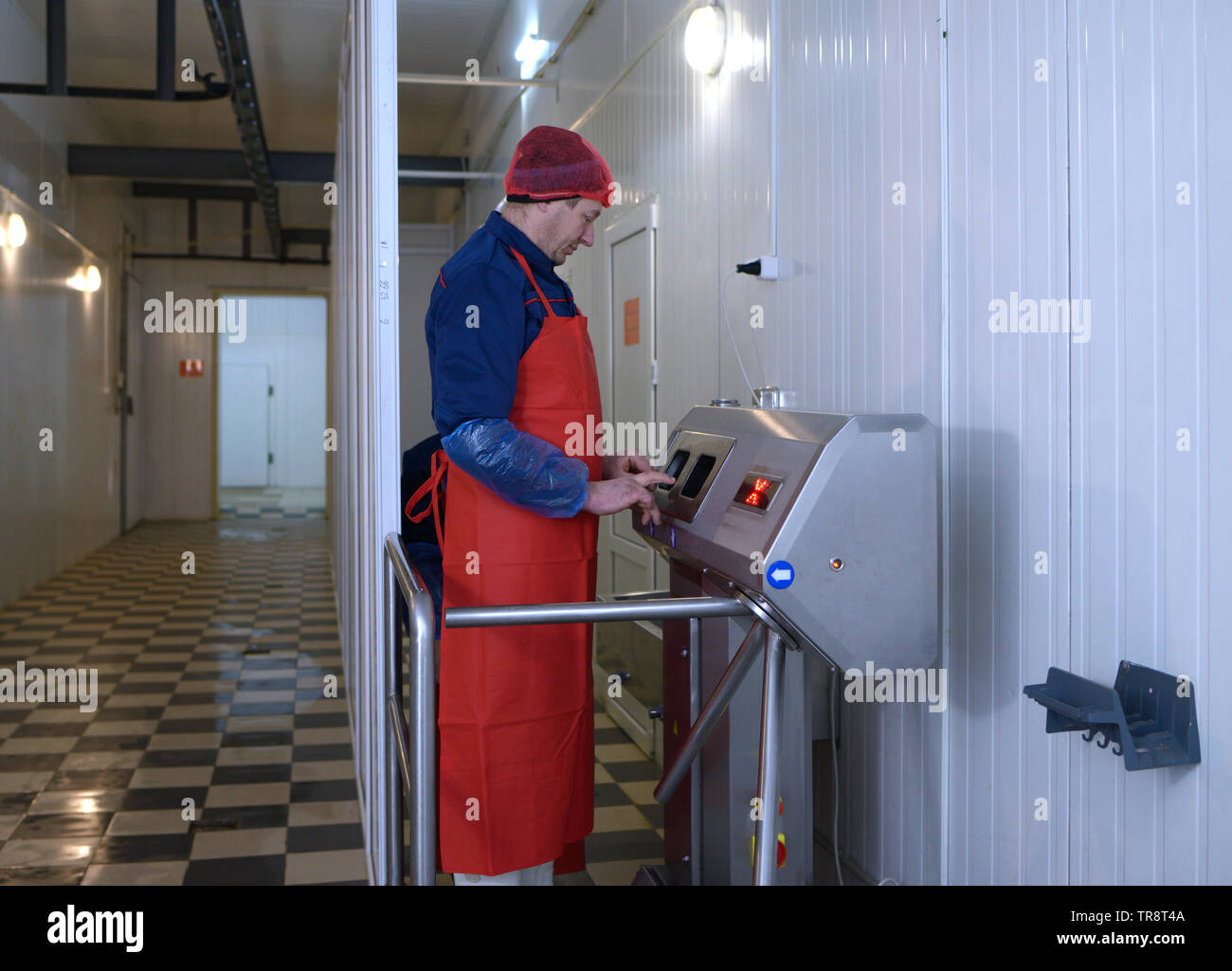 At the sanitary inspection room. Worker disinfecting hands before ...